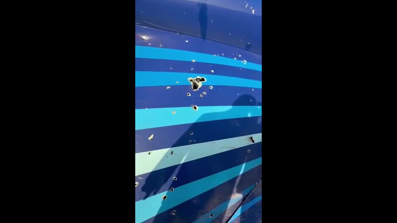 AZAL plane, the fuselage shows damage visually resembling the impact of ...